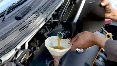 Pouring new engine oil into the vehicle'... | Stock Video | Pond5
