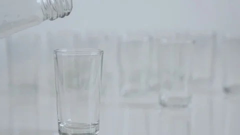 Pouring shot glasses on white background... | Stock Video | Pond5