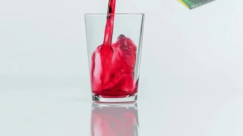 Pouring some red juice into a glass from... | Stock Video | Pond5