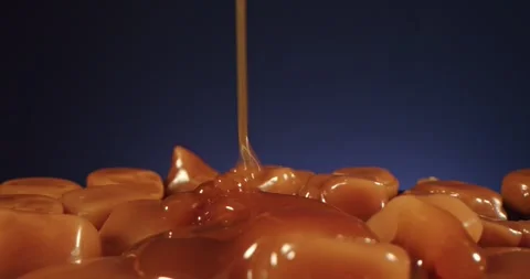 Pouring sweet caramel sauce on caramel b... | Stock Video | Pond5