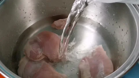 Pouring Water inside a Pot with a Chicke... | Stock Video | Pond5