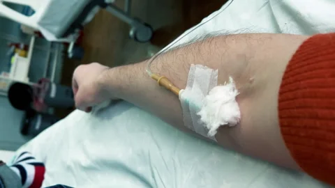 POV of a man's arm with an IV needle in ... | Stock Video | Pond5