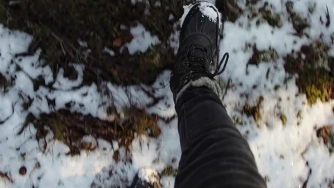 POV of person looking down at snow boots... | Stock Video | Pond5