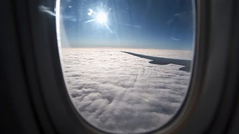 POV plane: looking out window of sun, gl... | Stock Video | Pond5