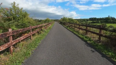 POV ride on fenced gravel bicycle path i... | Stock Video | Pond5