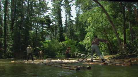 POV shot of men pushing log rafts down a... | Stock Video | Pond5