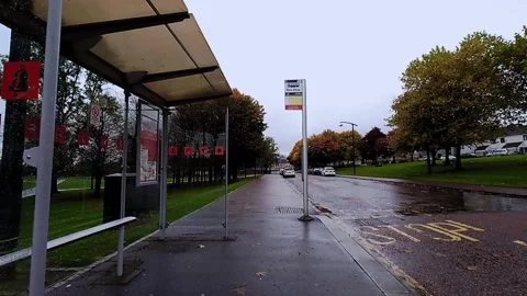POV of walking past an empty bus stop | Stock Video | Pond5