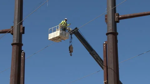 Power Line construction worker lifted hi... | Stock Video | Pond5