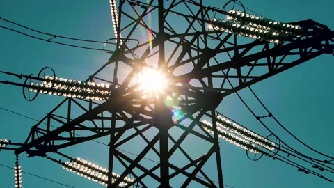 Power lines with sun rays on blue sky. H... | Stock Video | Pond5