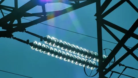 Power lines with sun rays on blue sky. H... | Stock Video | Pond5
