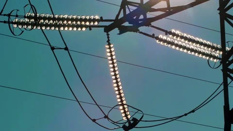 Power lines with sun rays on blue sky. H... | Stock Video | Pond5