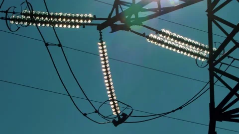 Power lines with sun rays on blue sky. H... | Stock Video | Pond5