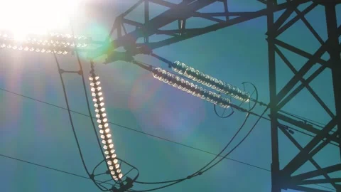 Power lines with sun rays on blue sky. H... | Stock Video | Pond5