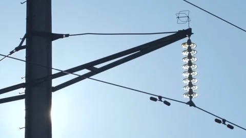 Power lines with sun rays on blue sky. H... | Stock Video | Pond5