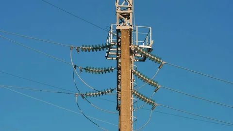 Power lines with sun rays on blue sky. H... | Stock Video | Pond5