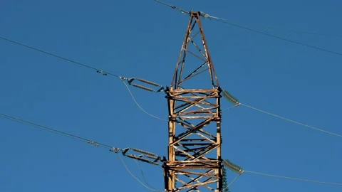 Power lines with sun rays on blue sky. H... | Stock Video | Pond5
