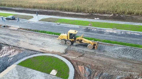 A powerful grader is leveling the road a... | Stock Video | Pond5