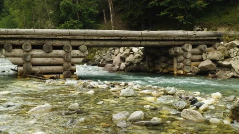 Powerful long wooden log bridge and clea... | Stock Video | Pond5