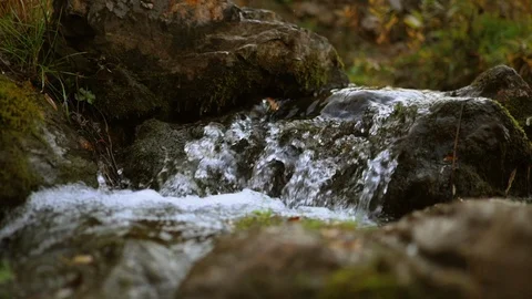 A powerful stream of water flows through... | Stock Video | Pond5