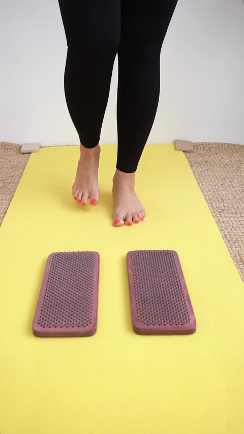 Practice of standing on nails. Young wom... | Stock Video | Pond5