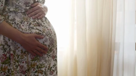 Pregnant women caressing her belly slow ... | Stock Video | Pond5