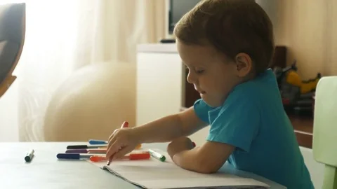 Preschool boy focused on drawing by felt... | Stock Video | Pond5
