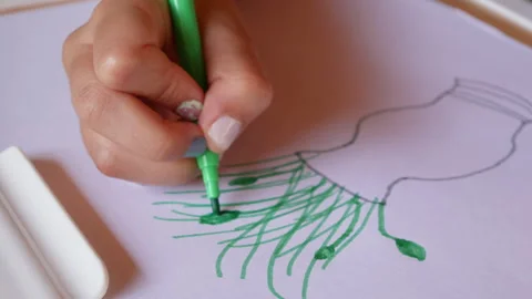 Preschool girl's hand drawing flowers in... | Stock Video | Pond5
