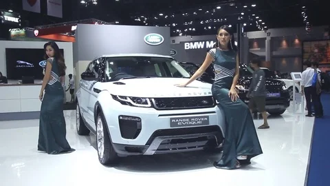 Presenters with Land Rover cars on displ... | Stock Video | Pond5