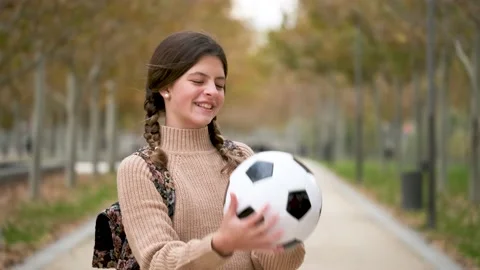 Preteen girl grabbing a soccer ball, smi... | Stock Video | Pond5