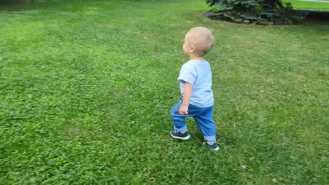Pretty baby boy learning to walk. Cute k... | Stock Video | Pond5