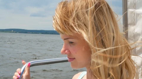 Pretty beautiful woman sailing on a boat | Stock Video | Pond5