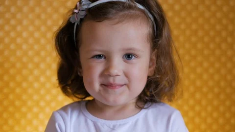 Pretty child girl eating sweets and wink... | Stock Video | Pond5