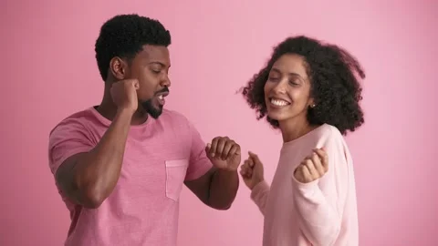 Pretty couple dancing in pink studio | Stock Video | Pond5