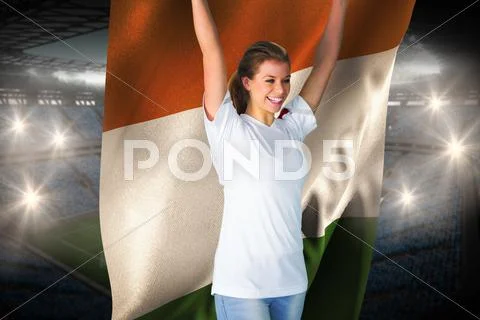 Pretty football fan in white cheering holding ivory coast flag: Graphic ...