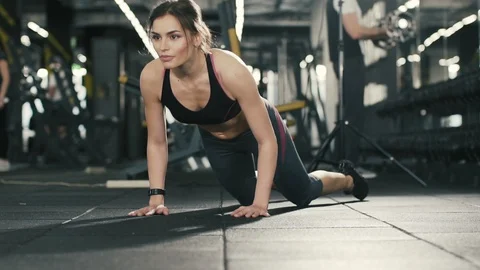 Pretty girl doing push ups at gym backgr... | Stock Video | Pond5