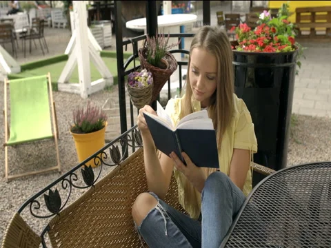 Pretty girl finish reading book in the o... | Stock Video | Pond5
