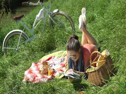 Pretty girl looks bored while reading bo... | Stock Video | Pond5