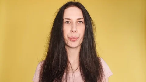 Pretty girl with messy hair blowing chew... | Stock Video | Pond5