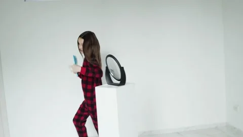 Pretty girl using her comb and dancing i... | Stock Video | Pond5