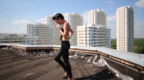 Pretty woman in costume dances on roof a... | Stock Video | Pond5
