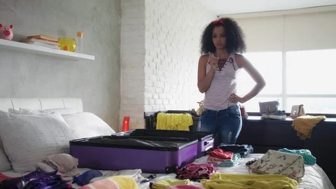 Pretty Young Black Woman Packing Bags Fo... | Stock Video | Pond5