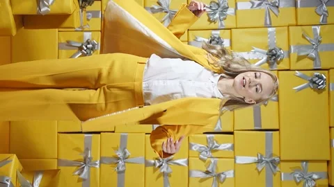 A pretty young blonde, dressed in a yell... | Stock Video | Pond5