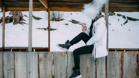 Pretty young girl vaping outside in good... | Stock Video | Pond5