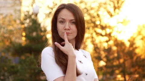 Pretty young woman look straight and put... | Stock Video | Pond5