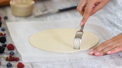 Pricking puff pastry sheet with fork. Ma... | Stock Video | Pond5