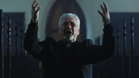 Priest on his knees praying and crying | Stock Video | Pond5