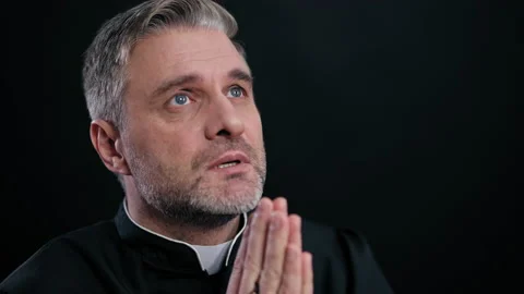 Priest looking up with eyes full of hope... | Stock Video | Pond5