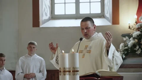 Priest raised hands up and reads prayer ... | Stock Video | Pond5