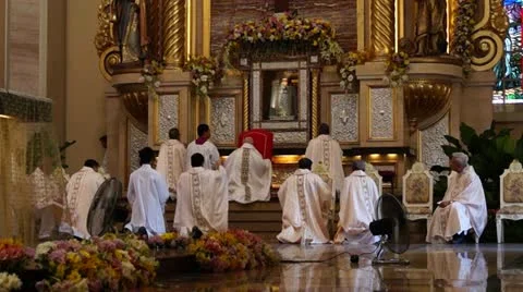 Priests kneeling in front of the altar | Stock Video | Pond5