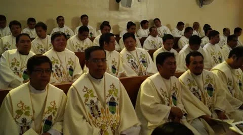 Priests seated on platform | Stock Video | Pond5